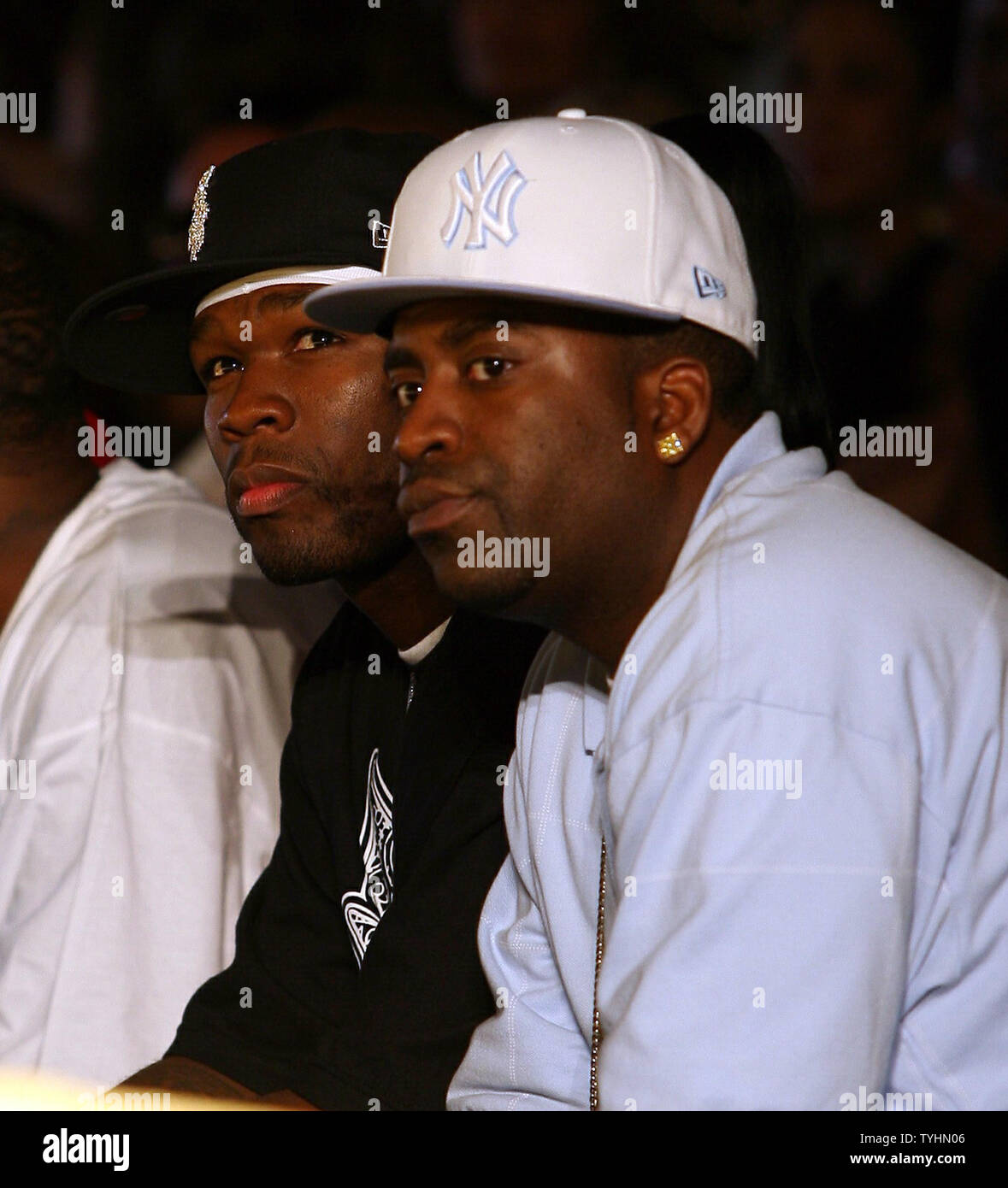50 Cent (left) sits in the front row at the Baby Phat by Kimora Lee ...