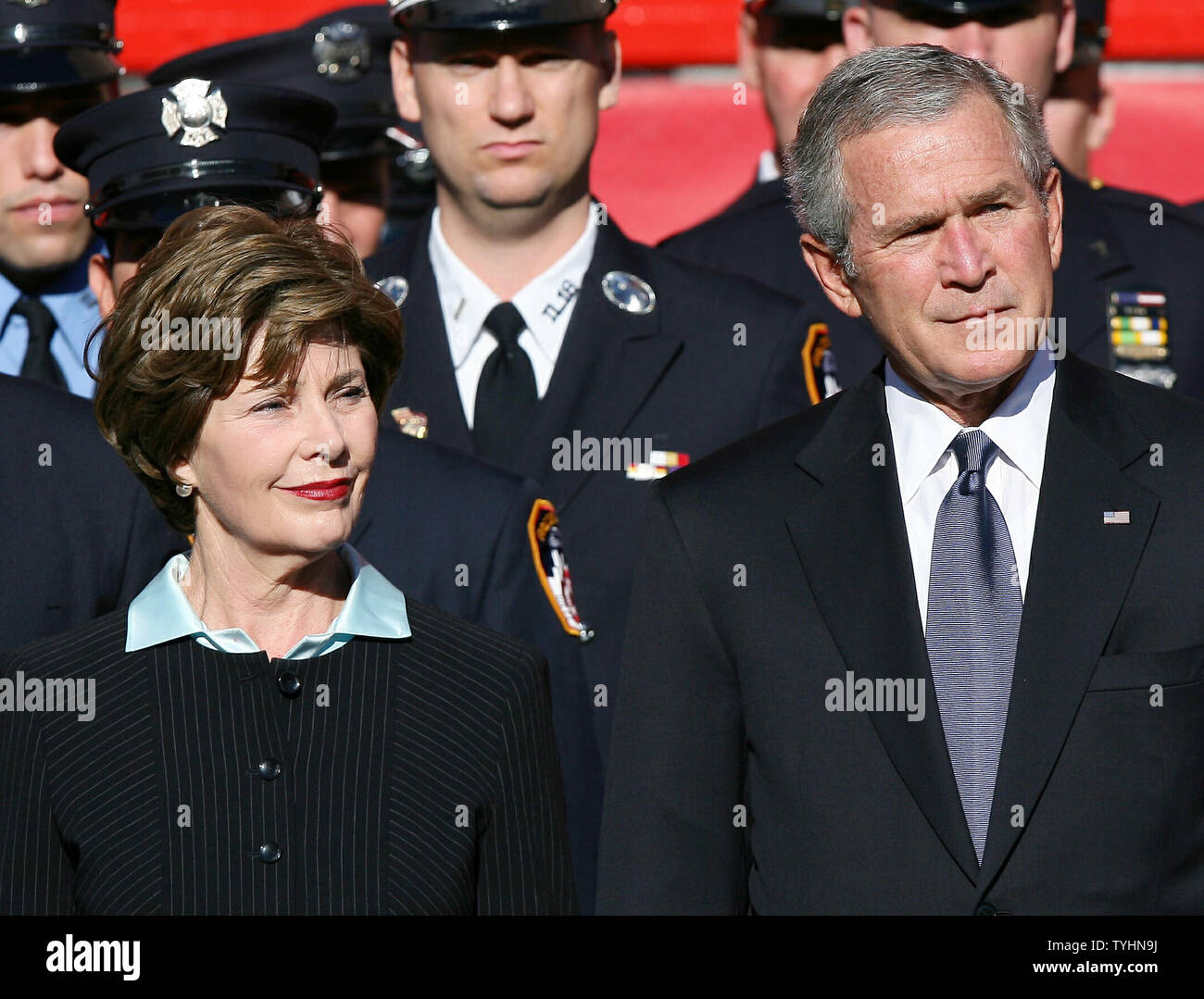 President George W. Bush and First Lady Laura Bush listen to the ...