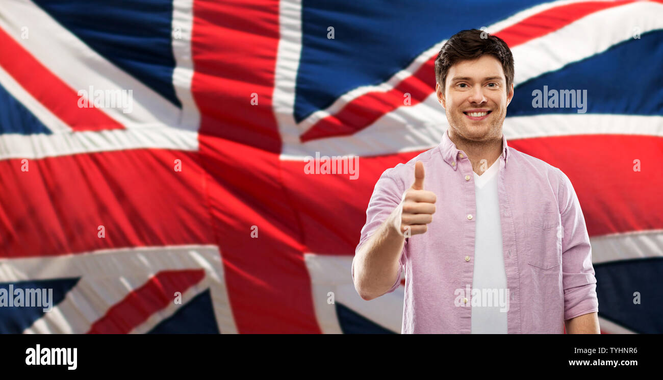 happy man showing thumbs up over british flag Stock Photo - Alamy
