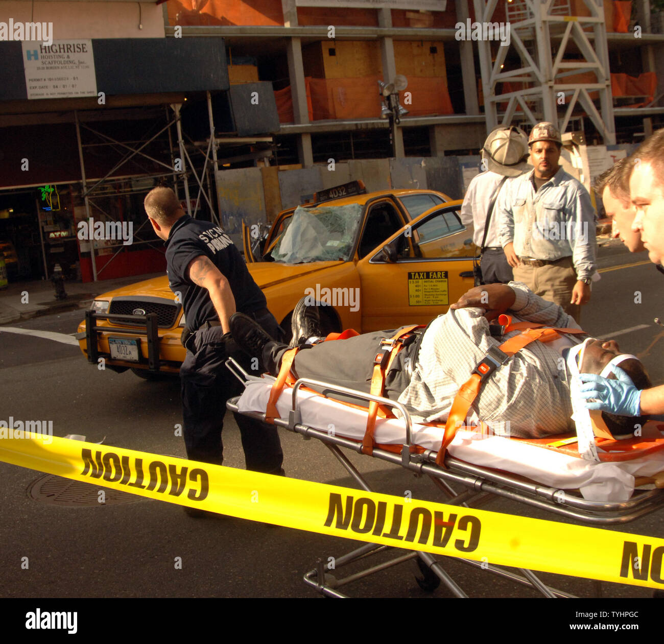 A New York City taxi cab driver is wheeled past his cab which was ...