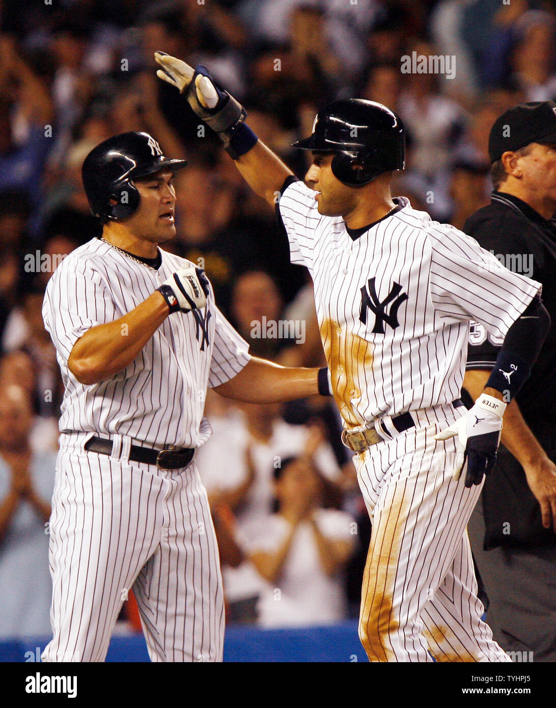 The New York Yankees Derek Jeter slaps Johnny Damon on the head after ...