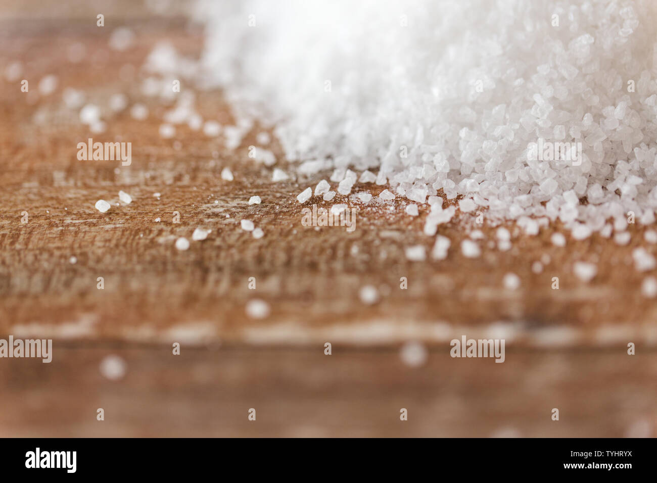 close up of white salt heap on wooden table Stock Photo - Alamy