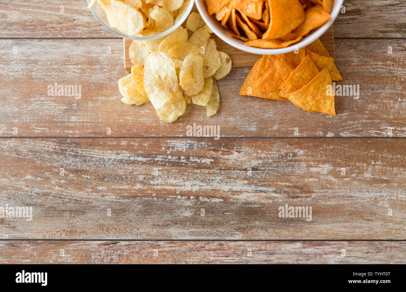 close up of potato crisps and nachos in bowls Stock Photo - Alamy