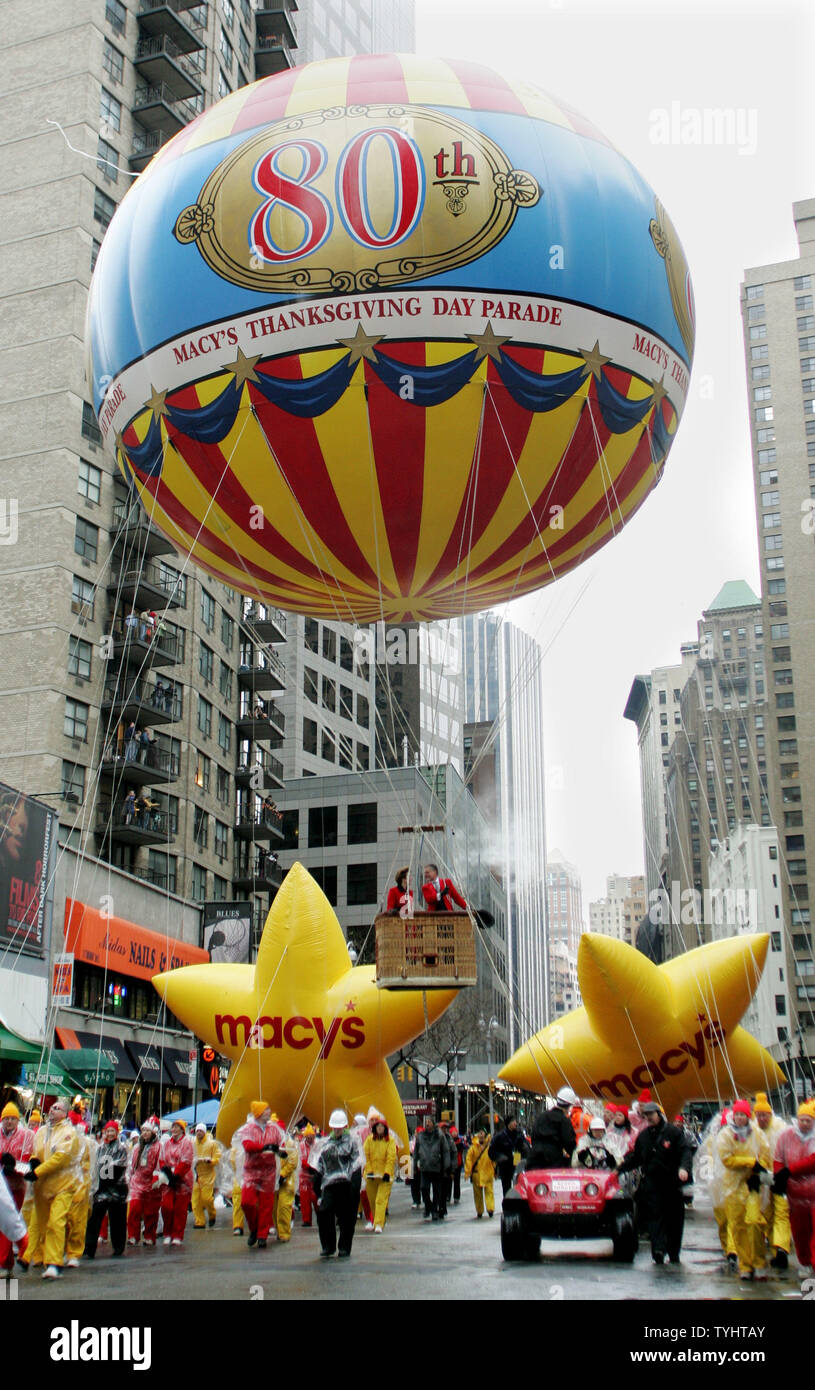 A giant balloon leads the 80th Macy's Thanksgiving Day parade down ...