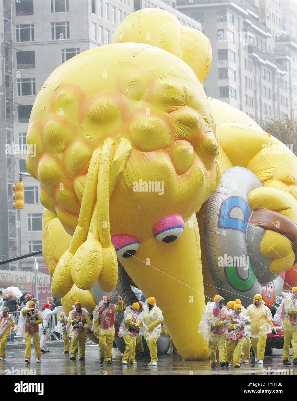 Gusty winds force the Big Bird float's nose to the ground as the rain ...