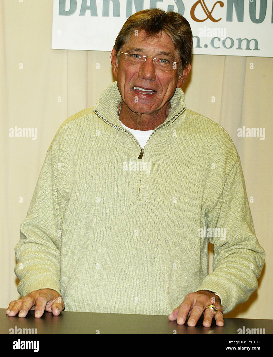 Football legend Joe Namath poses for the media before signing his ...