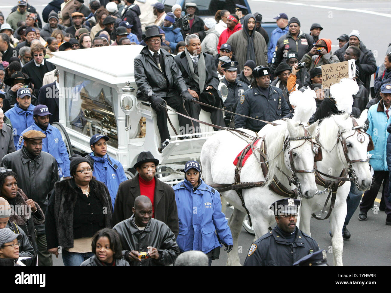 A horse-drawn carriage carries the casket of singer James Brown through ...