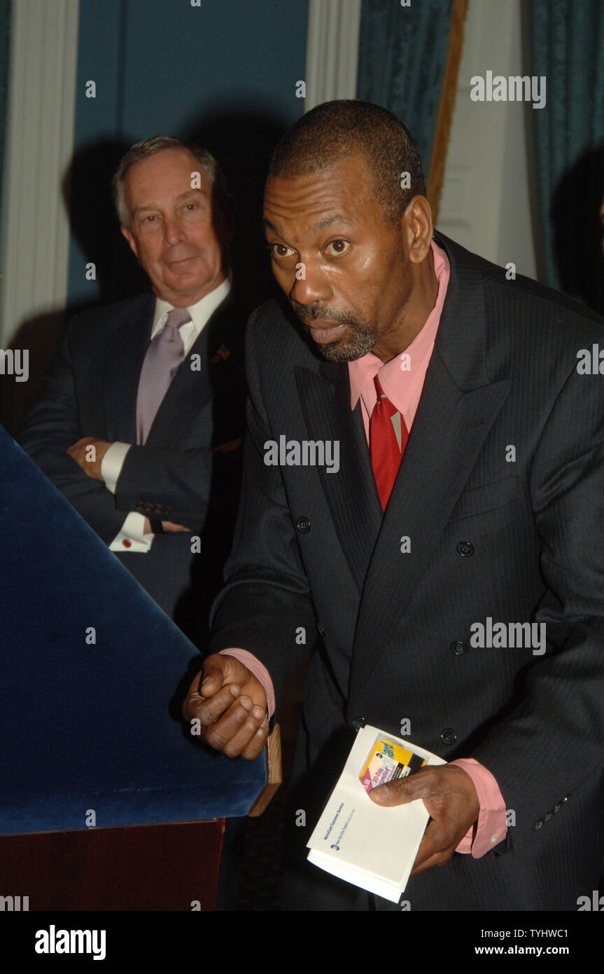 New York City Mayor Michael Bloomberg (left) listens to subway rescue ...