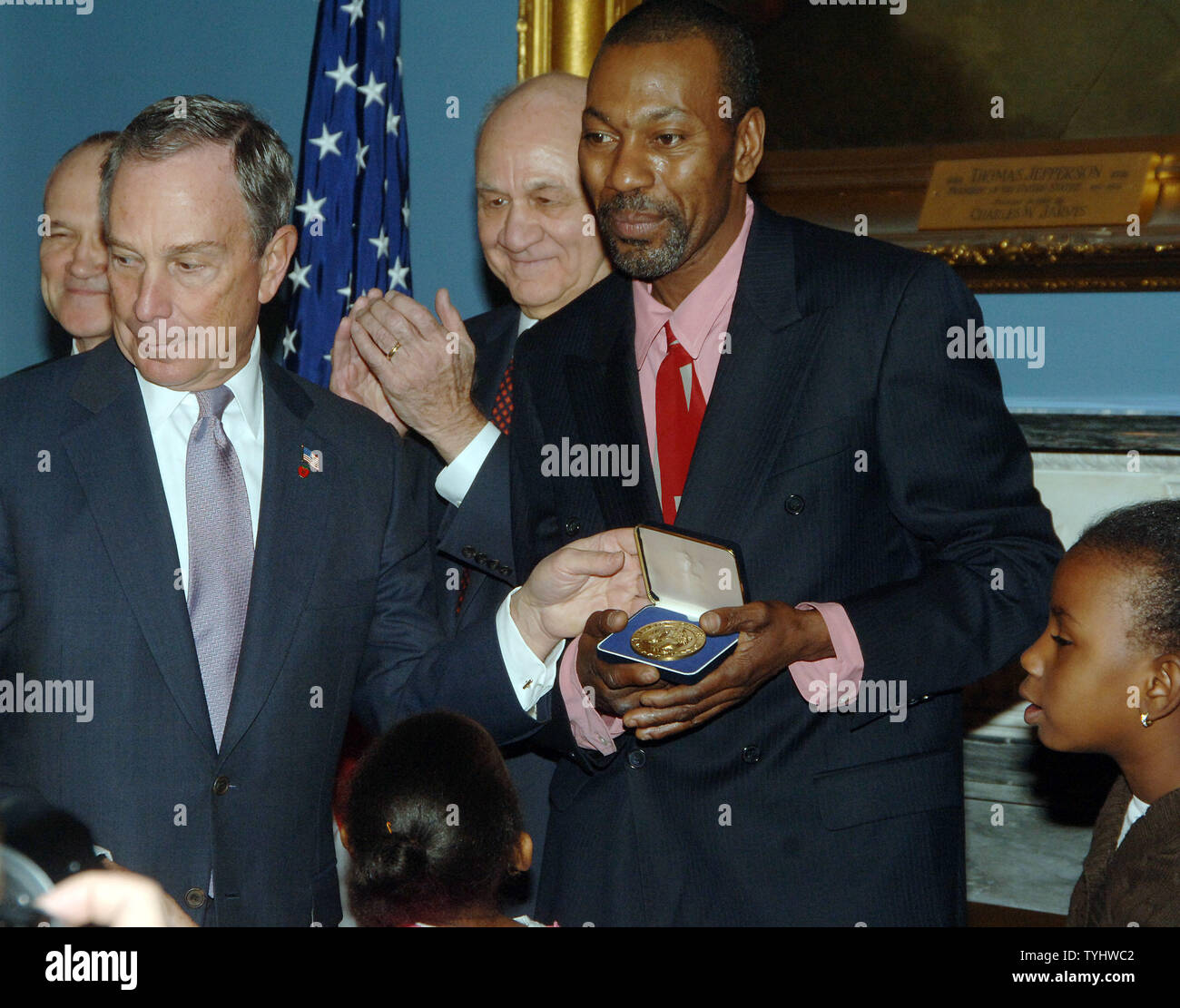 New York City Mayor Michael Bloomberg (left) hands the Bronze Medallion ...