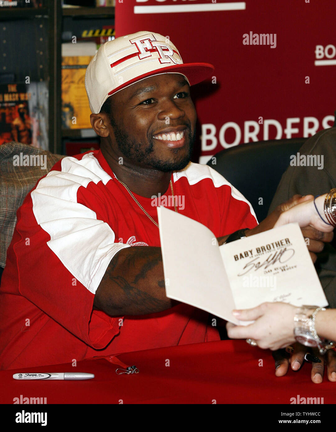 50 Cent signs copies of "Death Before Dishonor", "Baby Brother" and ...
