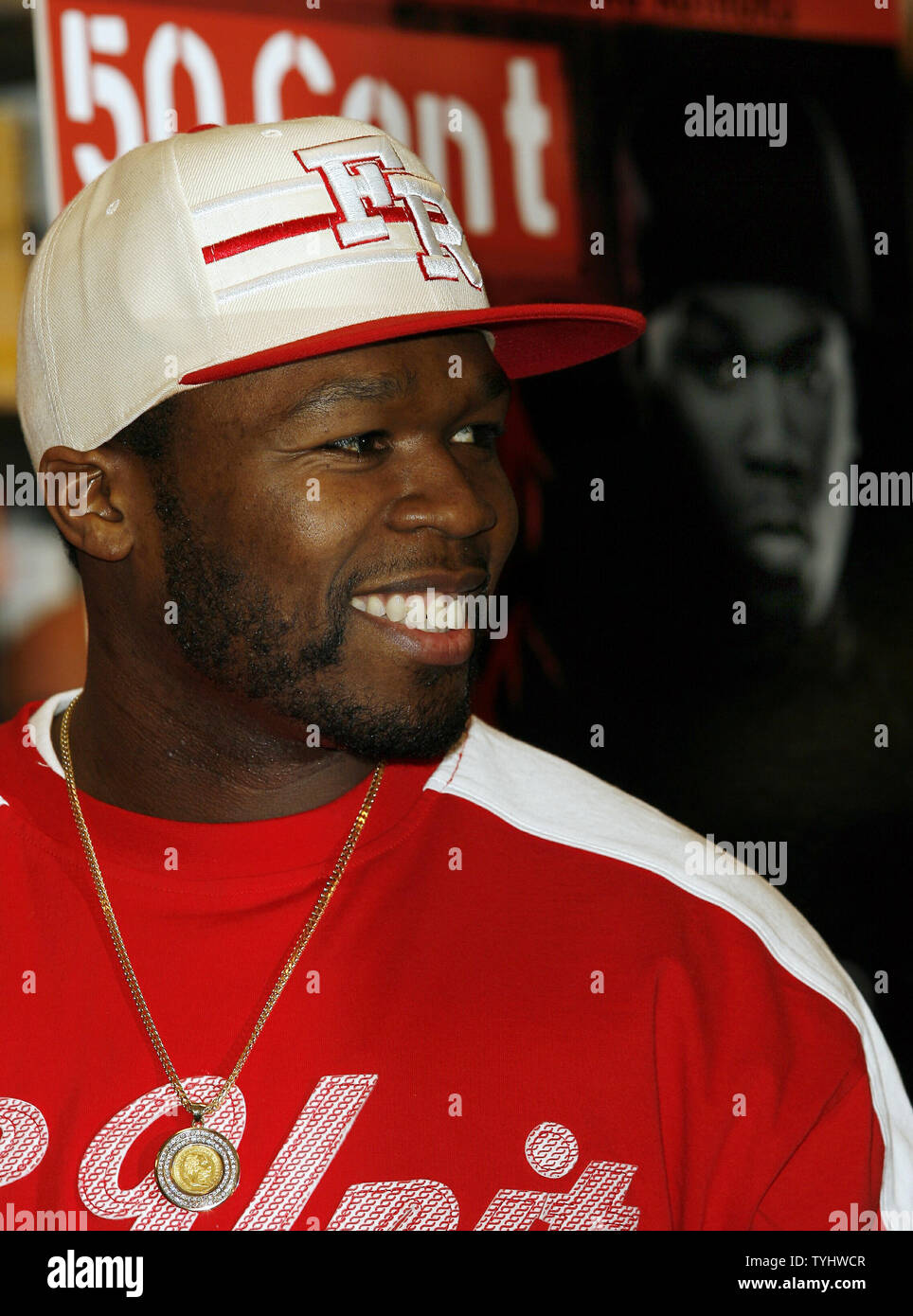50 Cent smiles before signing copies of "Death Before Dishonor", "Baby ...