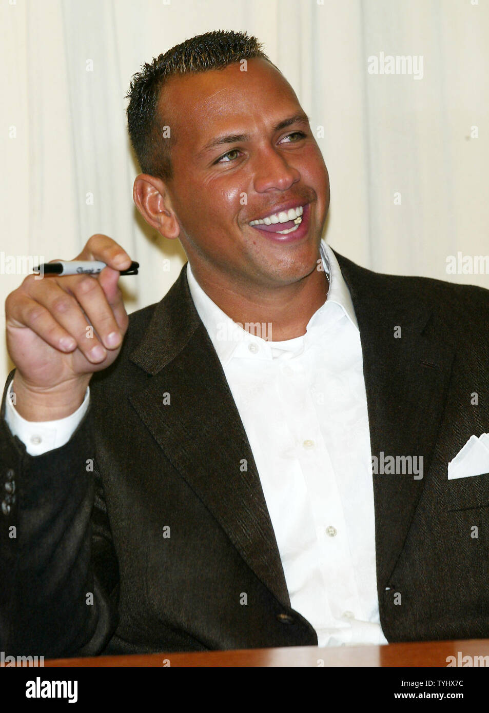 Alex Rodriguez ("A-Rod") poses for pictures before signing copies of ...