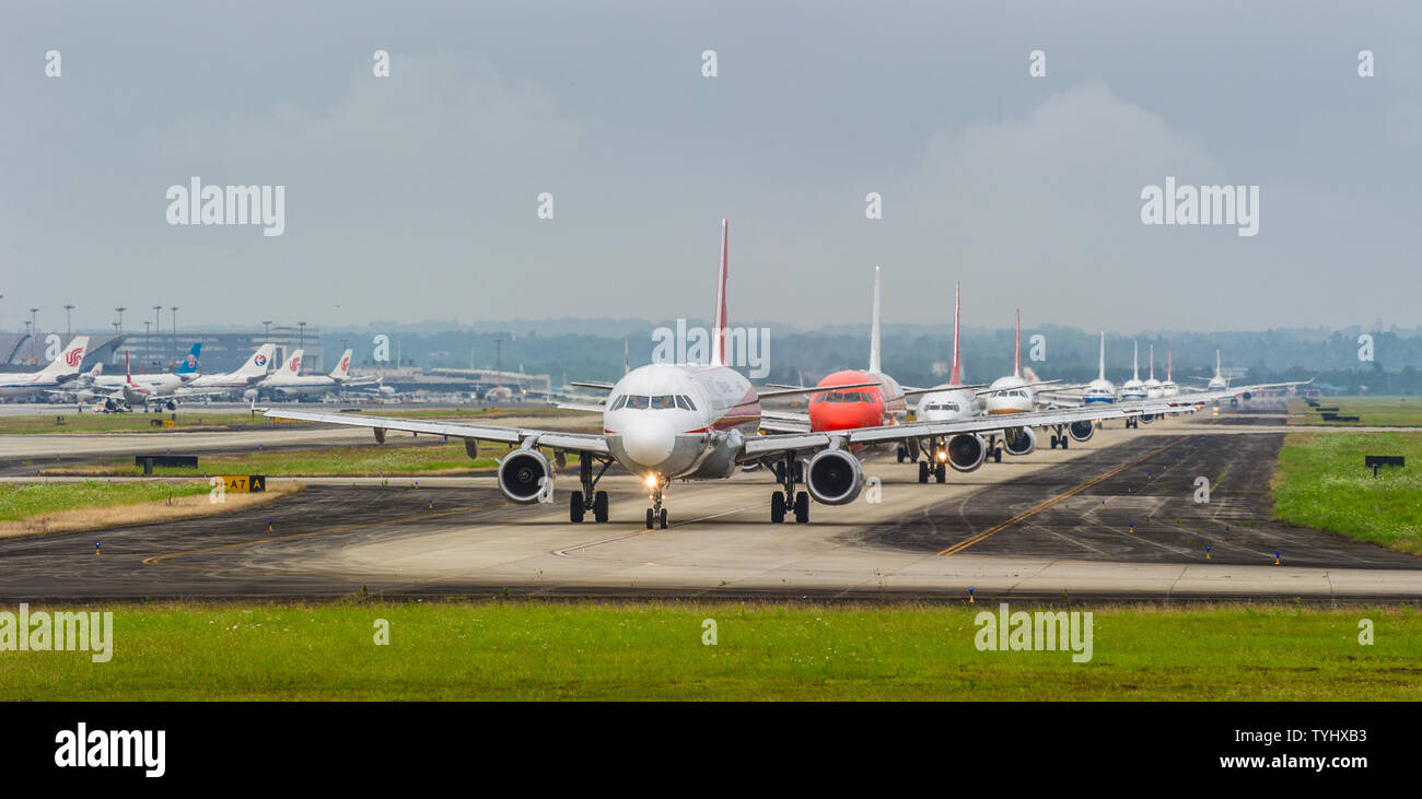 Civil aircraft waiting in line to take off Stock Photo - Alamy