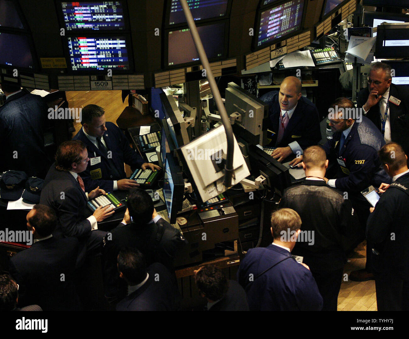 Wall Street employees work during the opening minutes of trading from ...