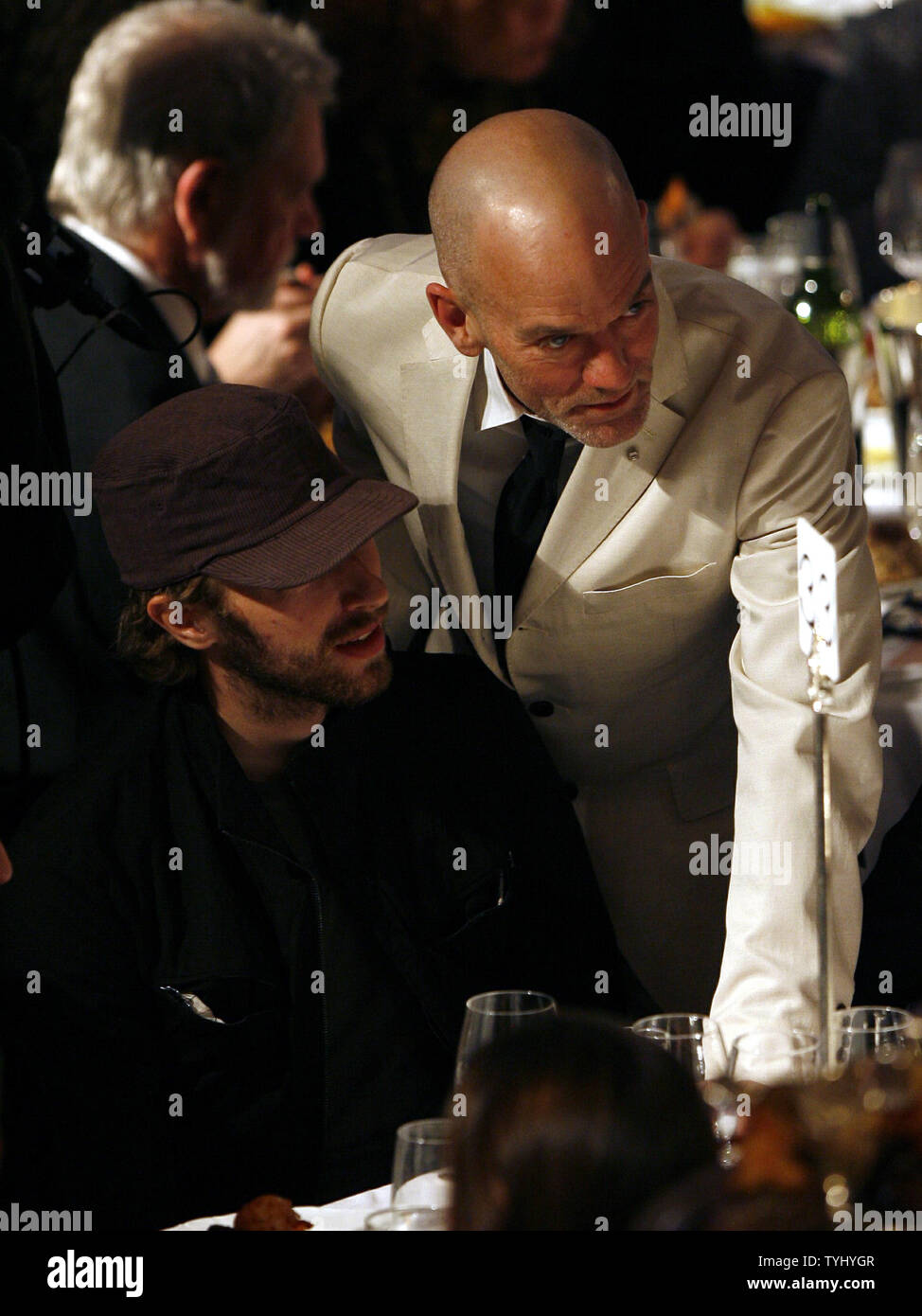 Michael Stipe puts his hand on the table of Chris Martin before the ...