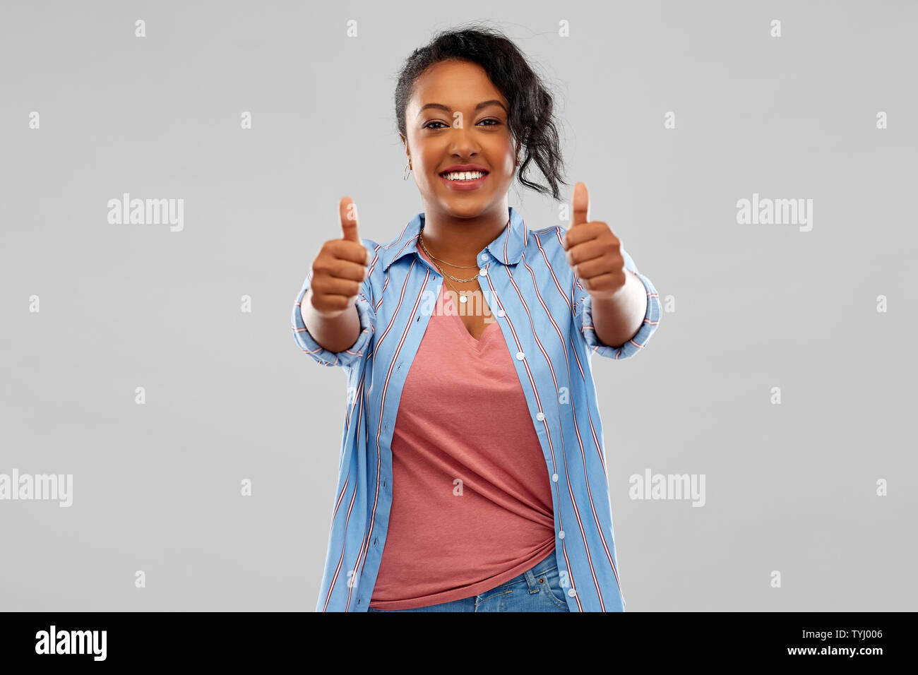 happy african american woman showing thumbs up Stock Photo - Alamy