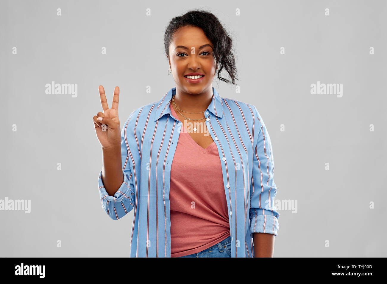 happy african american woman showing peace Stock Photo - Alamy