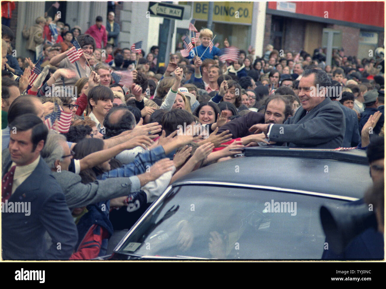 Richard M. Nixon's motorcade being swarmed by people during a campaign ...