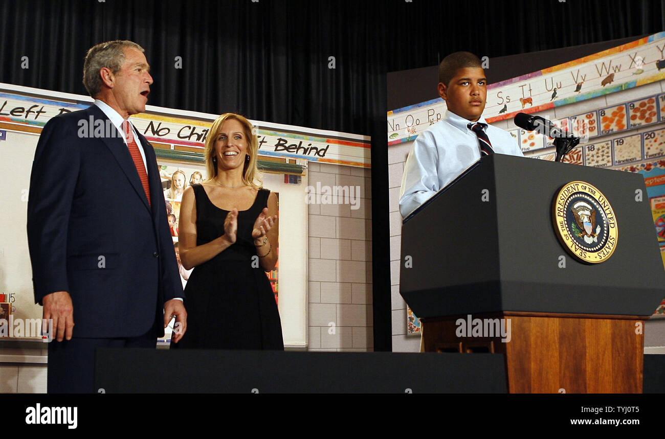 U.S. President George W. Bush and Deborah Kenny (C) listen to 8th grade ...