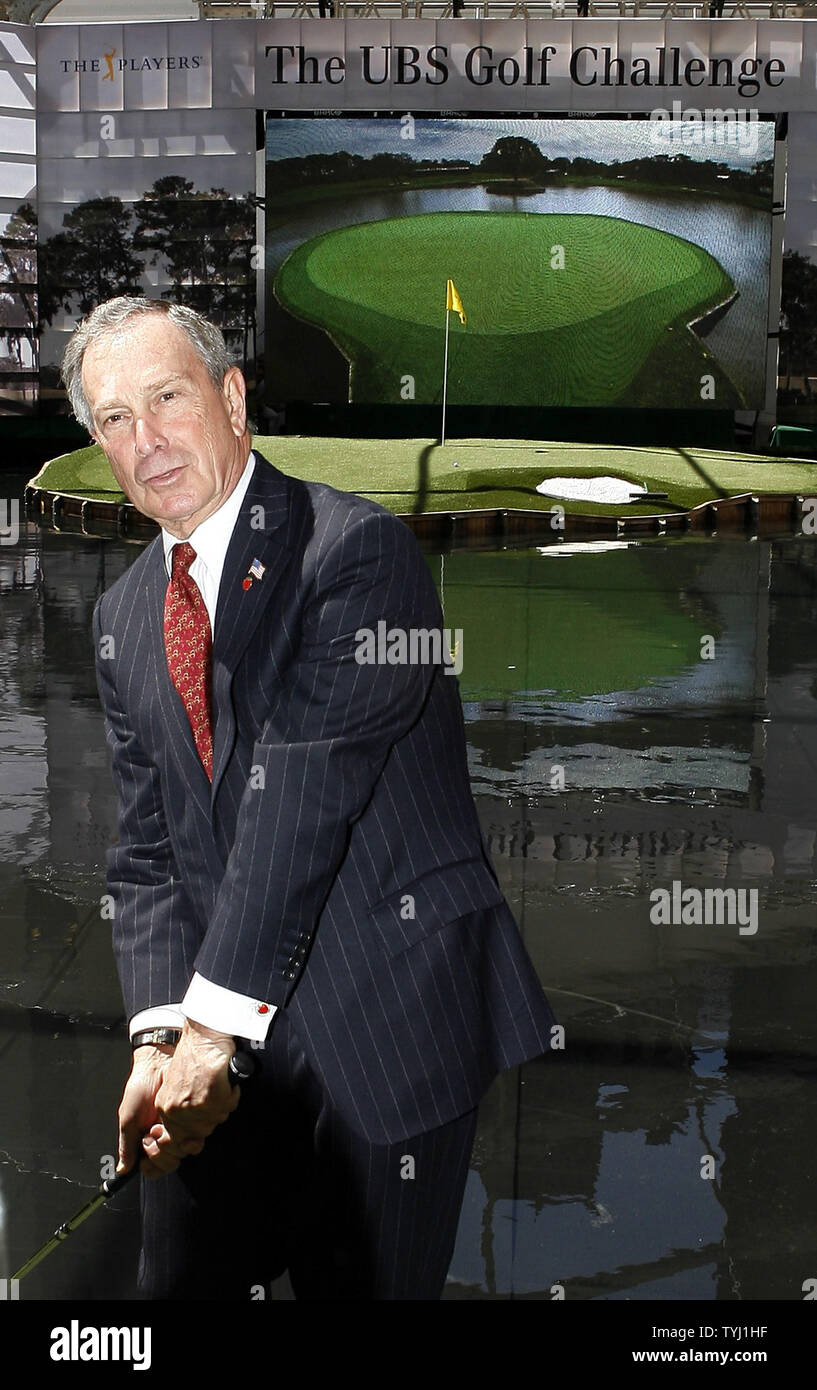 Mayor Michael Bloomberg holds a golf club while standing in front of a ...