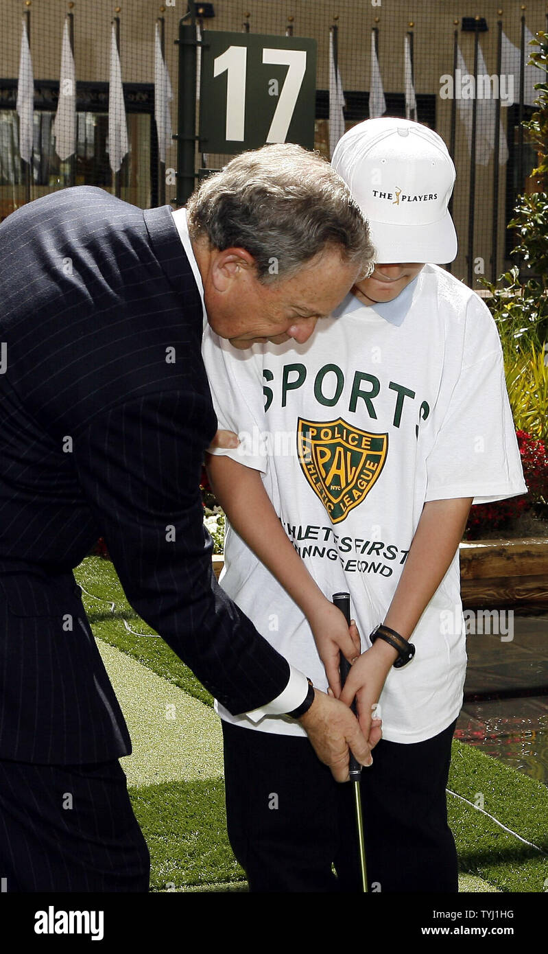 Mayor Michael Bloomberg helps a child from the Police Athletic League ...