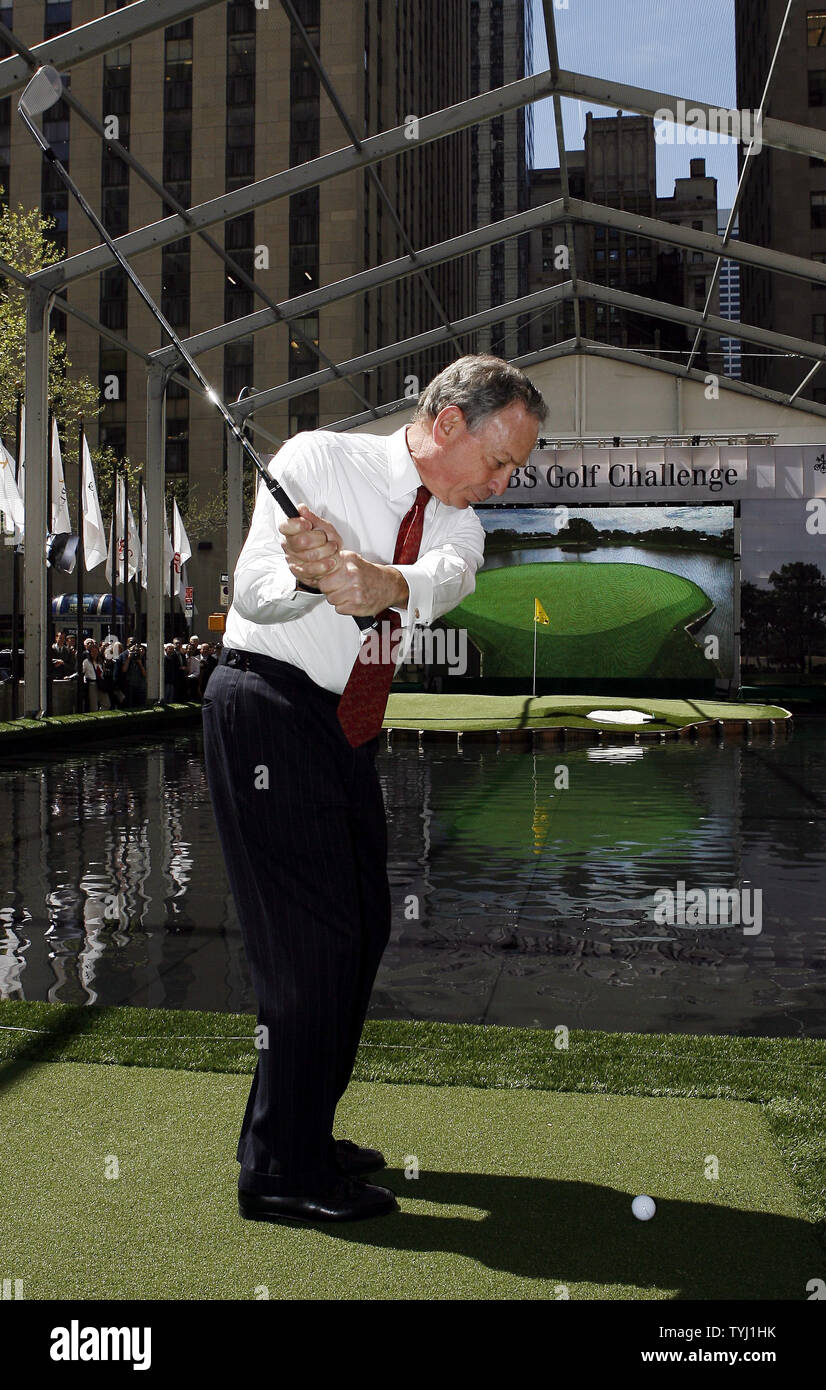 Mayor Michael Bloomberg hits a golf shot to a replica of the famed TPC ...