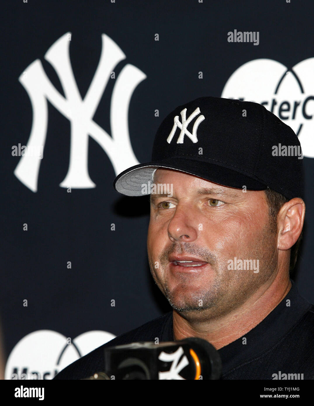 Roger Clemens answers questions at a press conference after signing ...