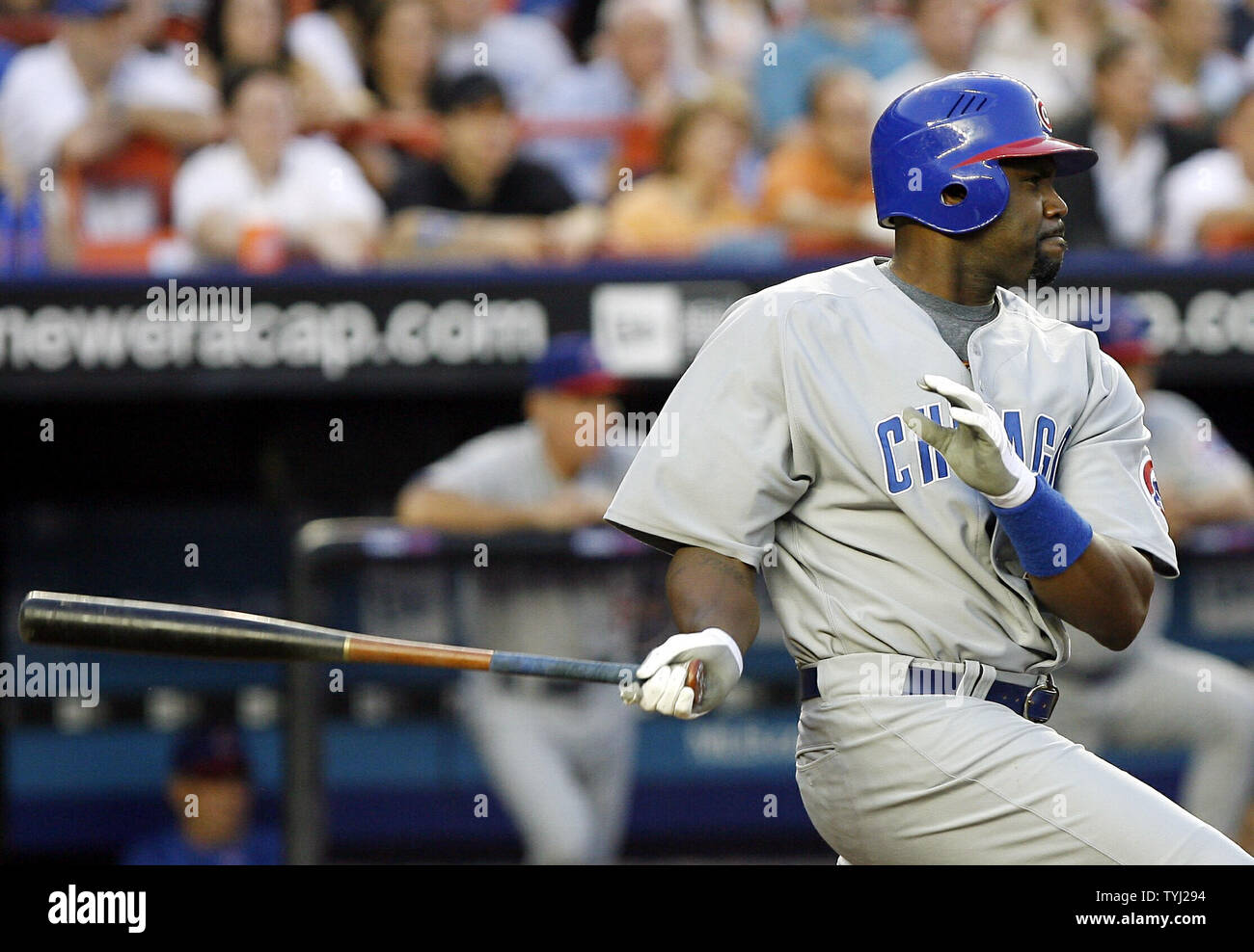 Chicago Cubs Cliff Floyd hits an RBI single against the New York Mets ...