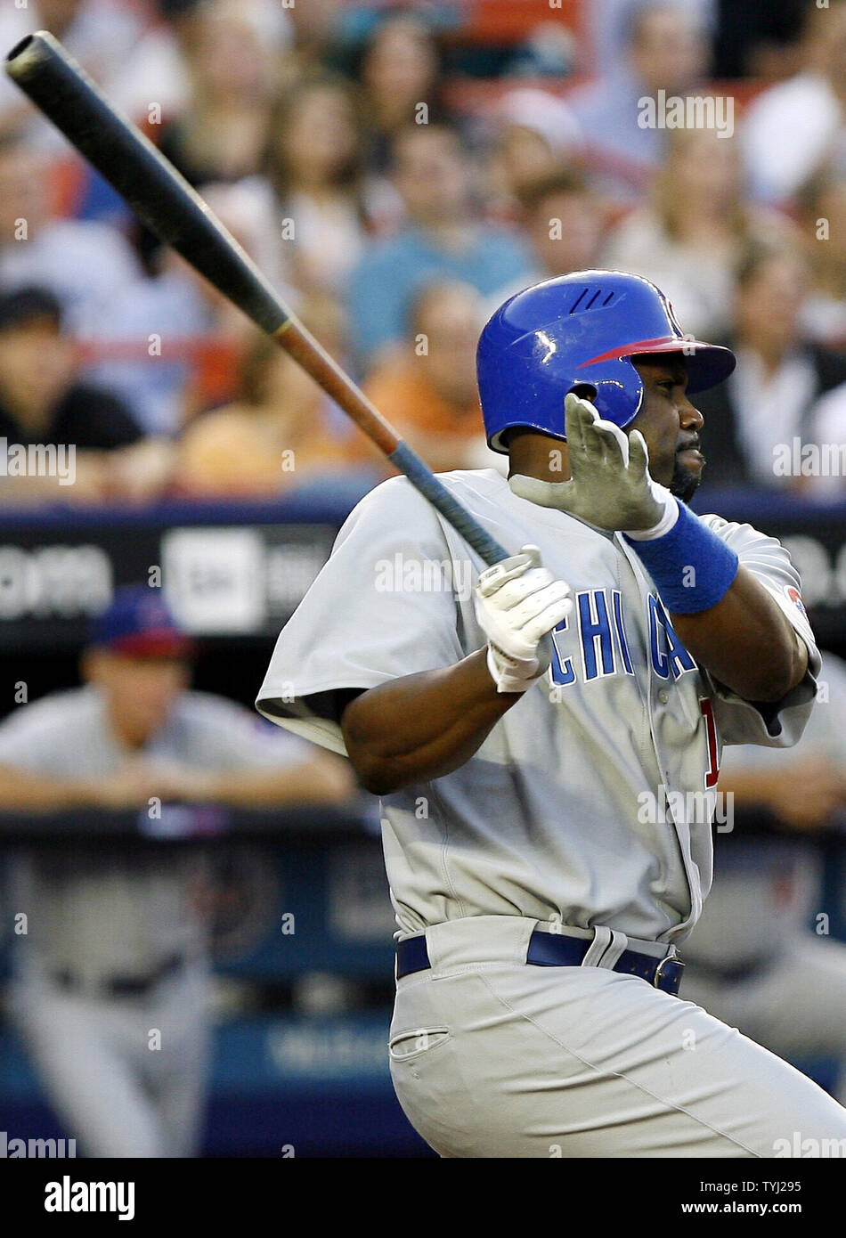 Chicago Cubs Cliff Floyd hits an RBI single against the New York Mets ...