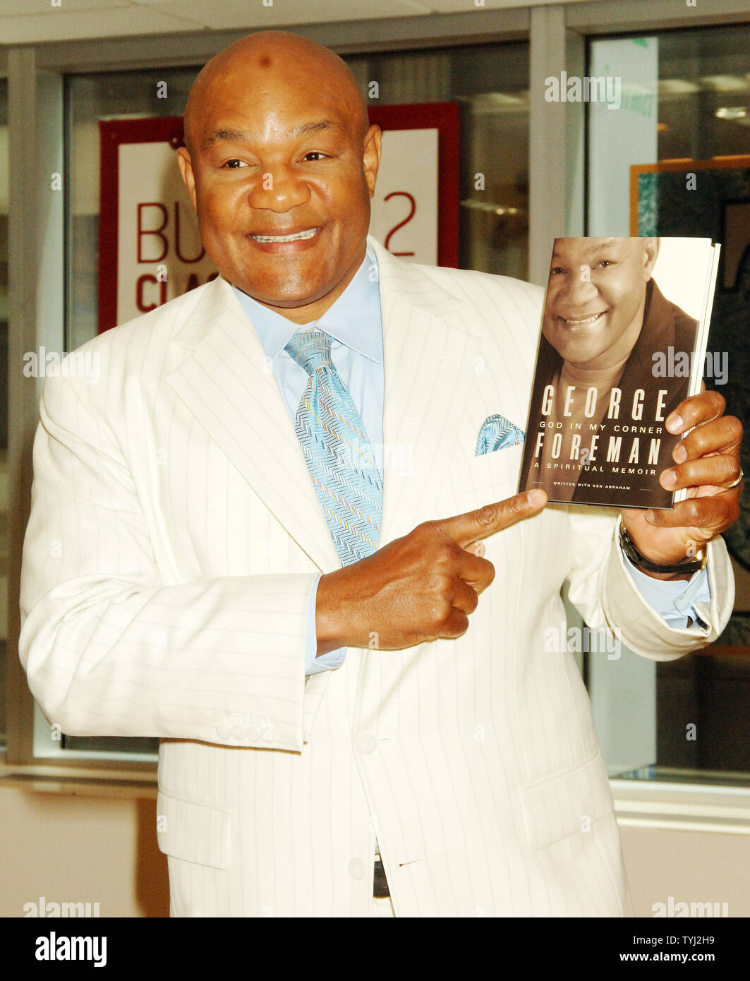 Former World Heavyweight champion George Foreman poses with a copy of ...