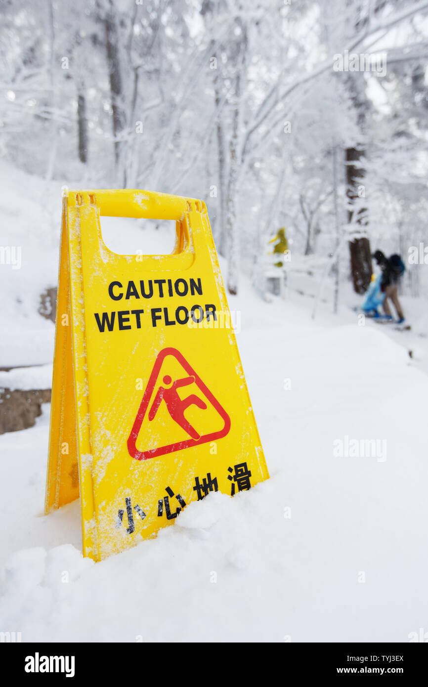 warning caution sign board on snow floor on hill Stock Photo - Alamy