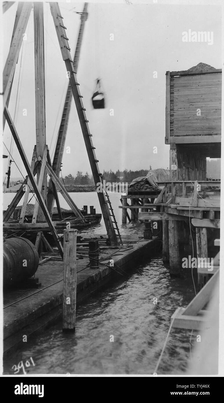 Rock bunkers and Lewis & Clark River, and clam shell unloading barge ...
