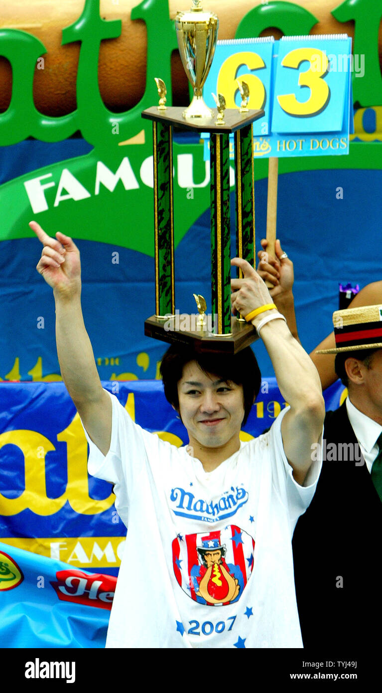 Six-time champion Takeru Kobayashi of Japan waves to fans as he holds ...