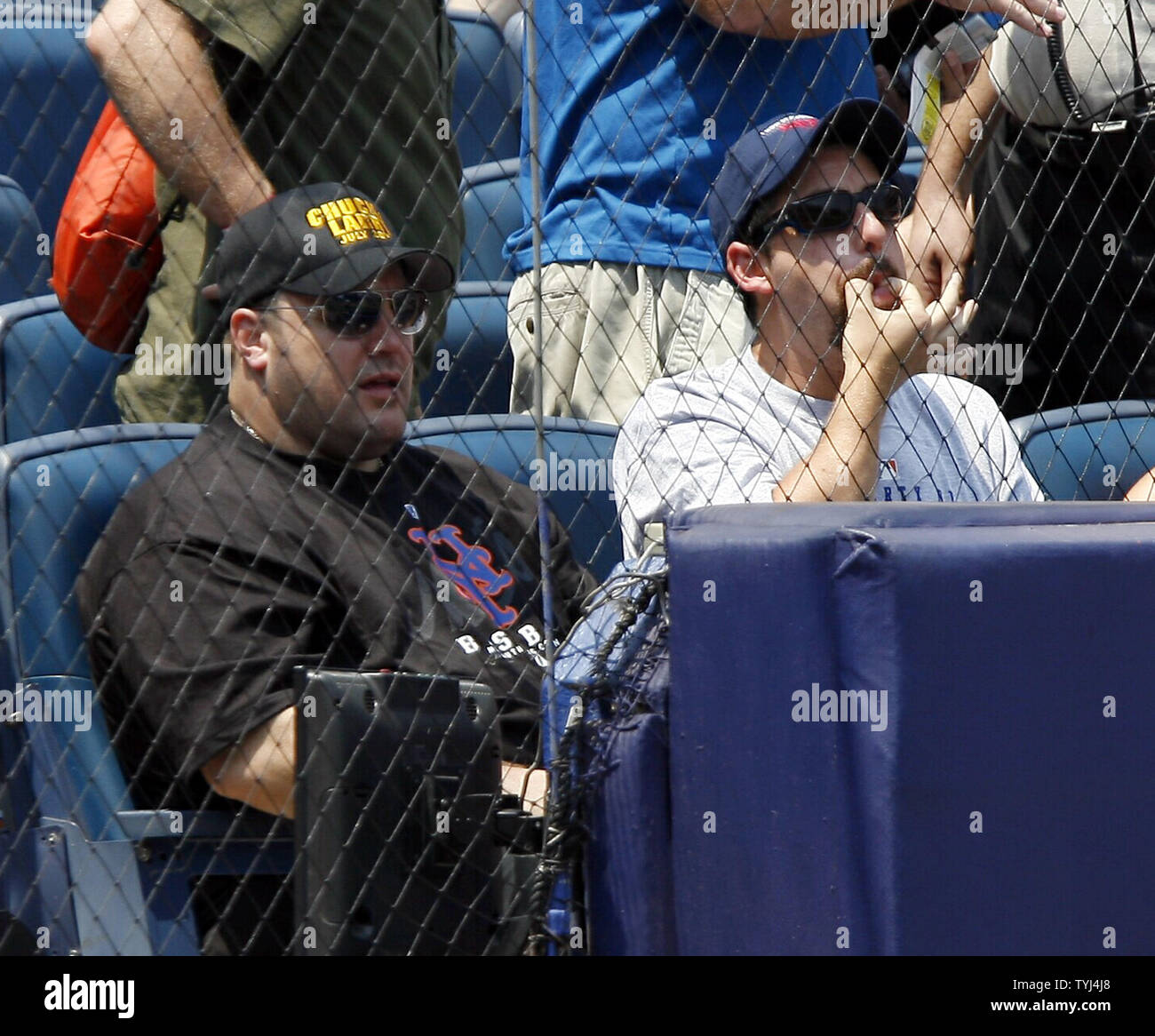 (L-R) Kevin James and Adam Sandler watch the New York Mets at Shea ...