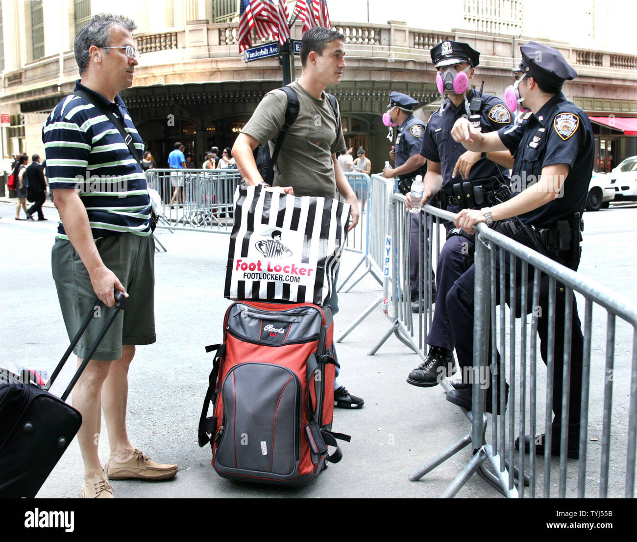 Police officers help redirect people around the street closure in front ...
