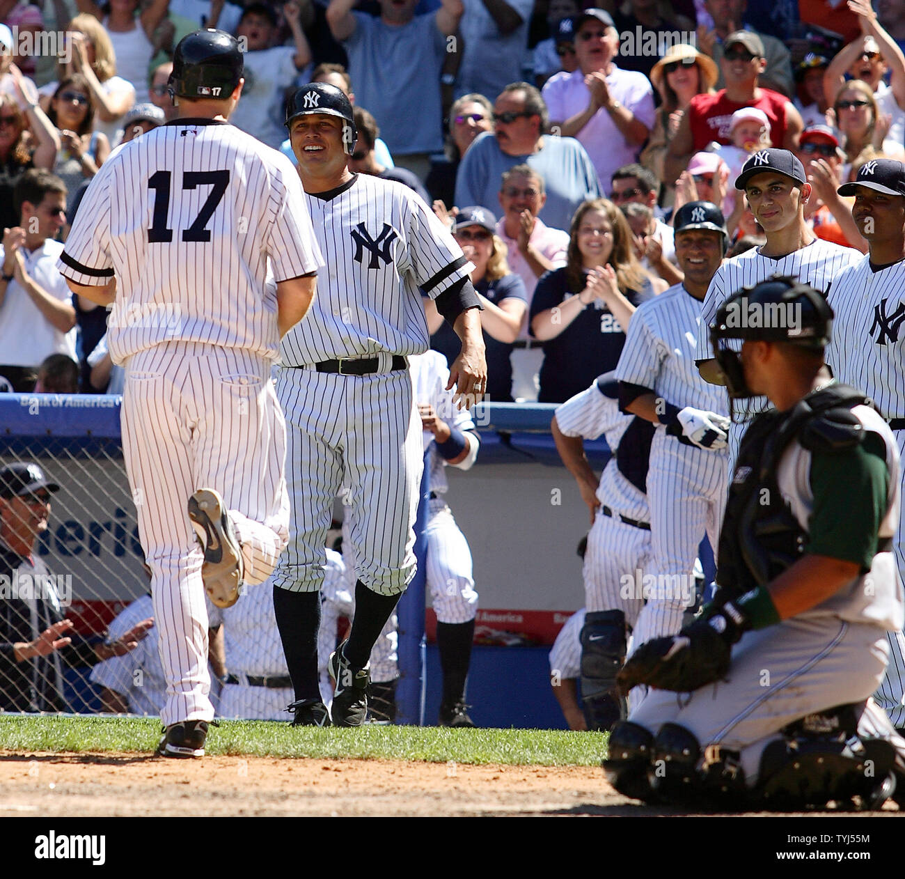 New York Yankees Shelly Duncan i(17) is greeted by Andy Phillips after ...