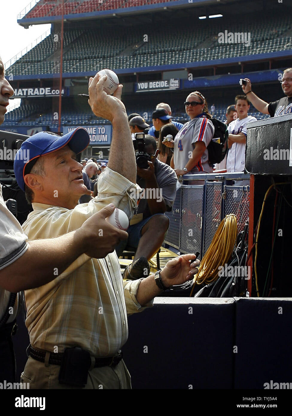 Robin Williams signs baseballs while shooting the movie "Old Dogs" at ...