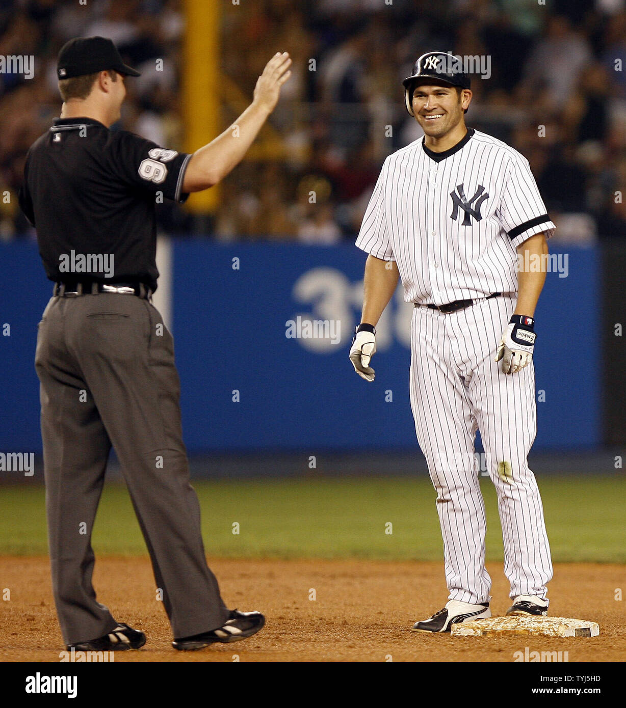 New York Yankees Johnny Damon smiles with second base umpire Adam Dowdy ...