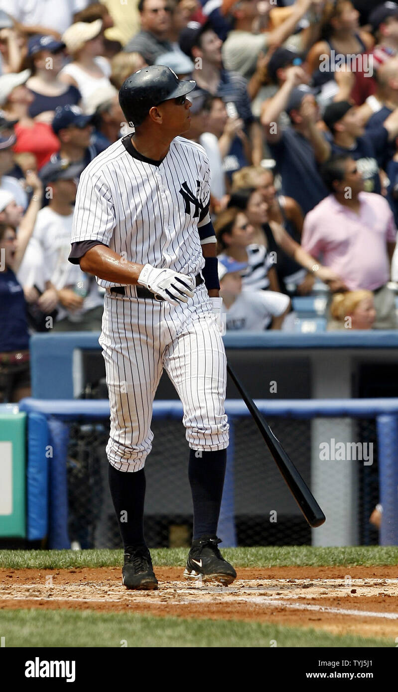 New York Yankees Alex Rodriguez takes time to watch the ball go over ...