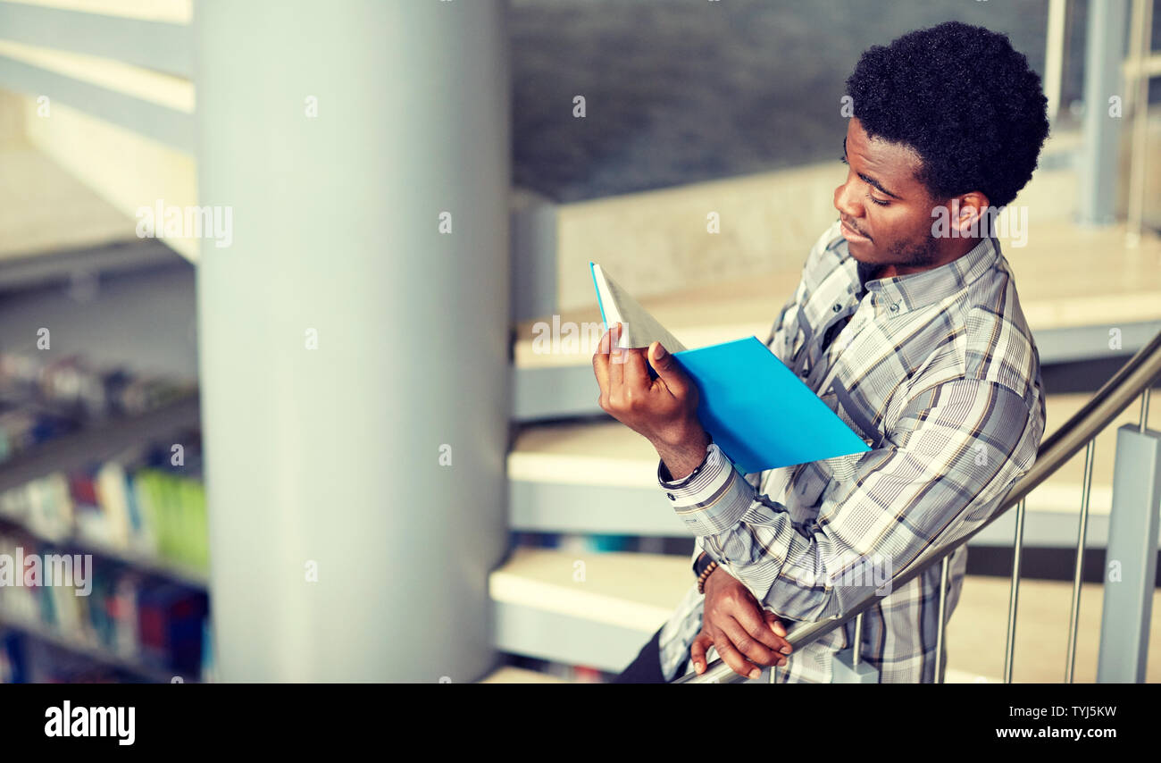 african student boy or man reading book at library Stock Photo - Alamy