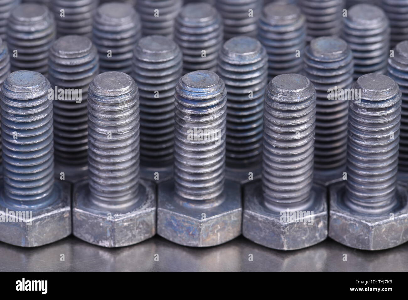 Steel bolts in row order Stock Photo - Alamy
