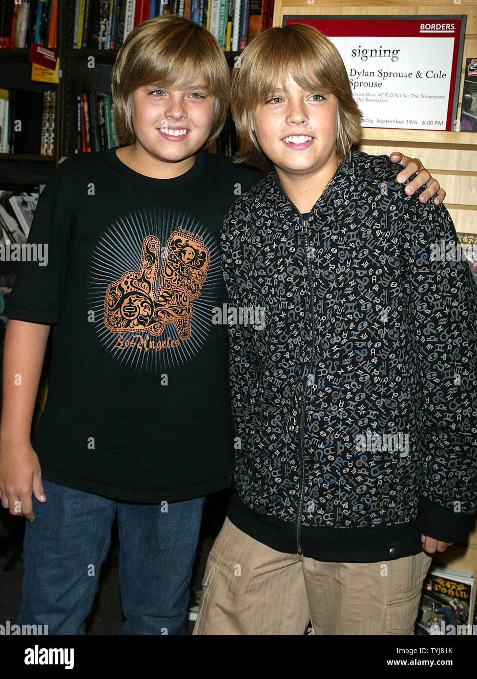 Dylan (L) and Cole Sprouse pose for pictures before signing copies of ...