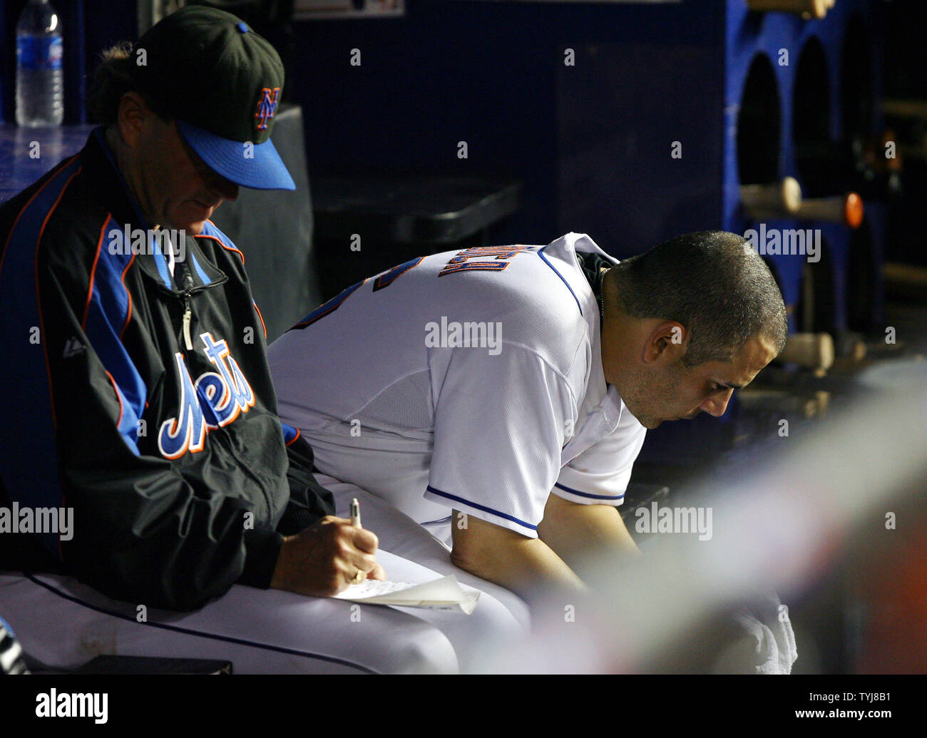 New York Mets Paul Lo Duca puts his head down in the dugout while ...