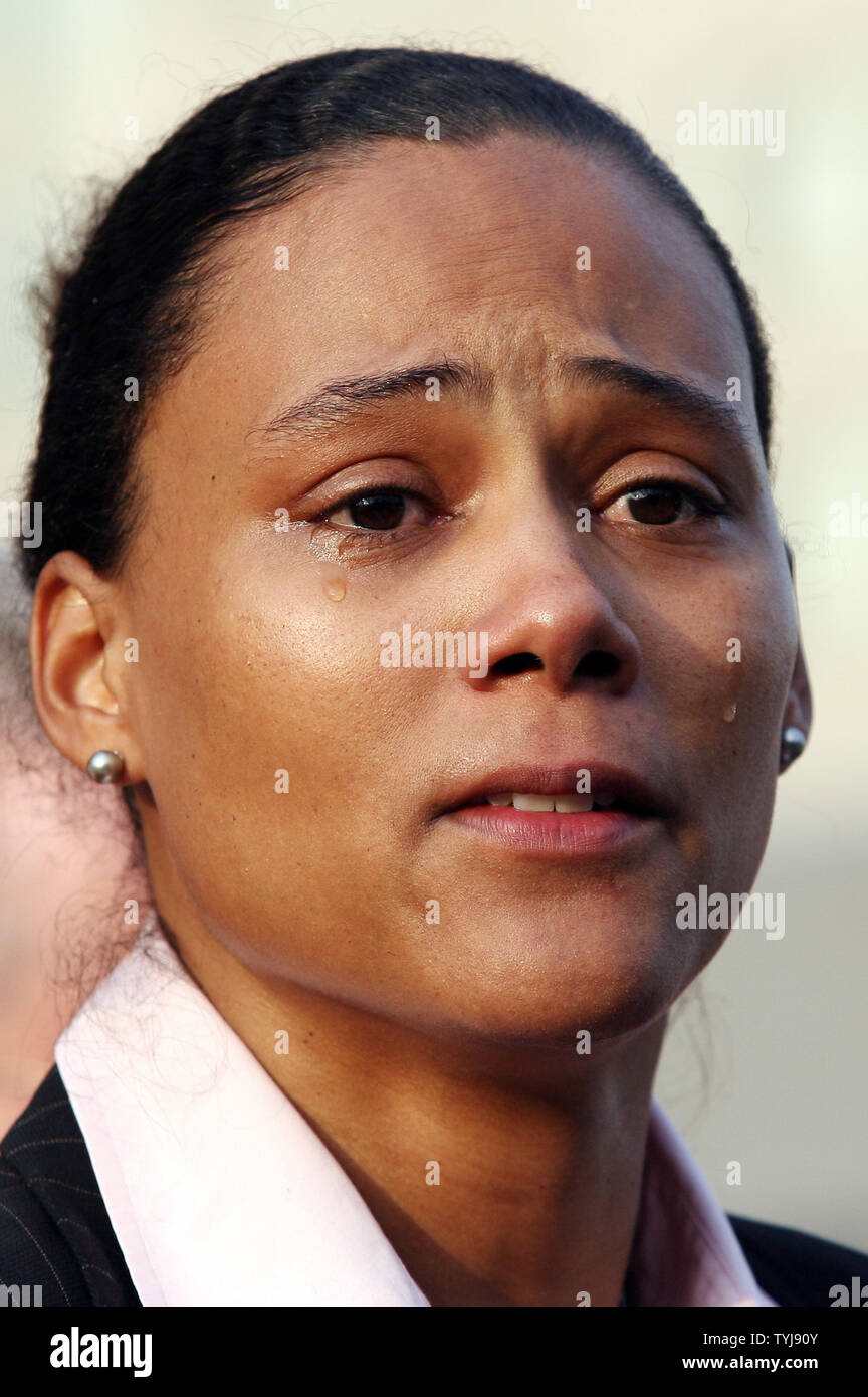 Marion Jones has tears in her eyes while speaking to the media outside ...