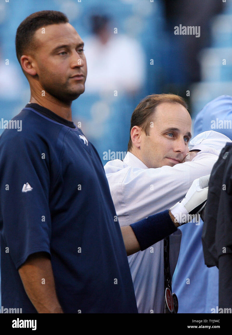 New York Yankees general manager Brian Cashman puts his head on the ...
