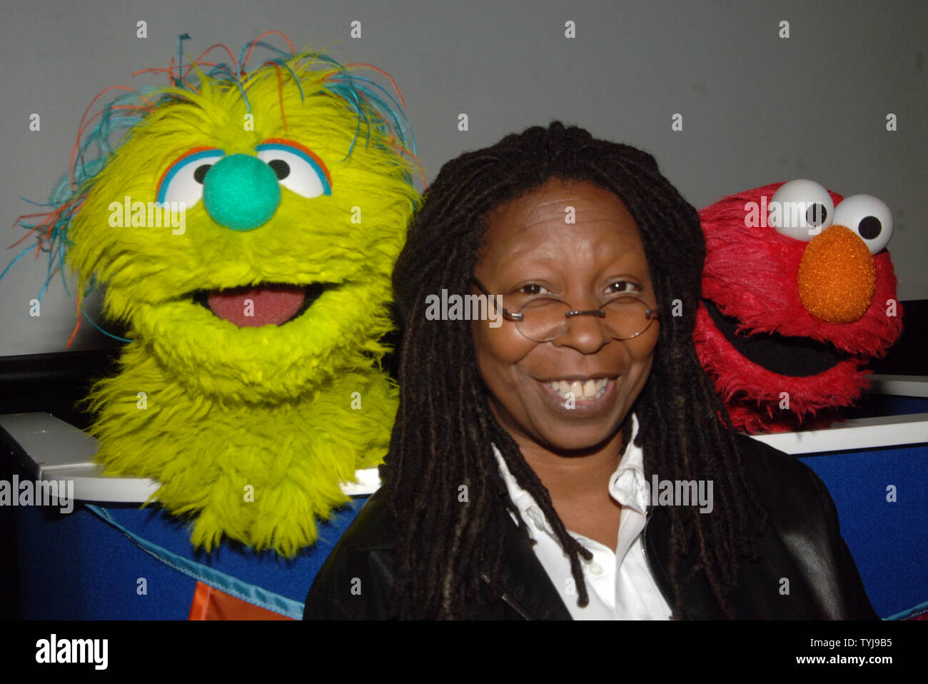 Actress Whoopi Goldberg poses with the new muppet Azibo (L) and Elmo (R ...
