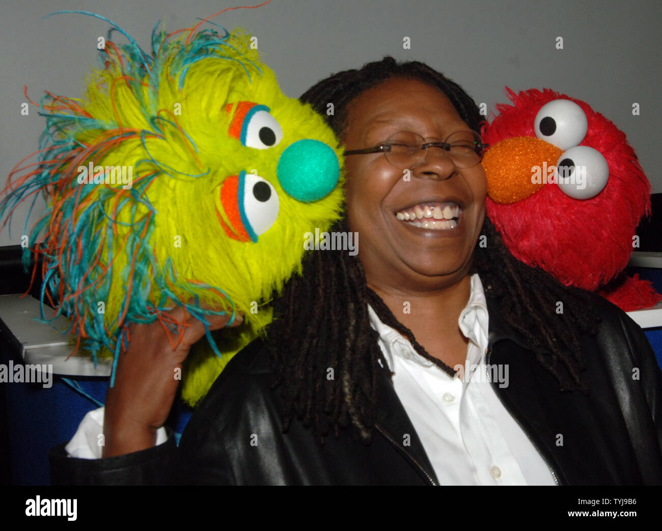 Actress Whoopi Goldberg poses with the new muppet Azibo (L) and Elmo (R ...