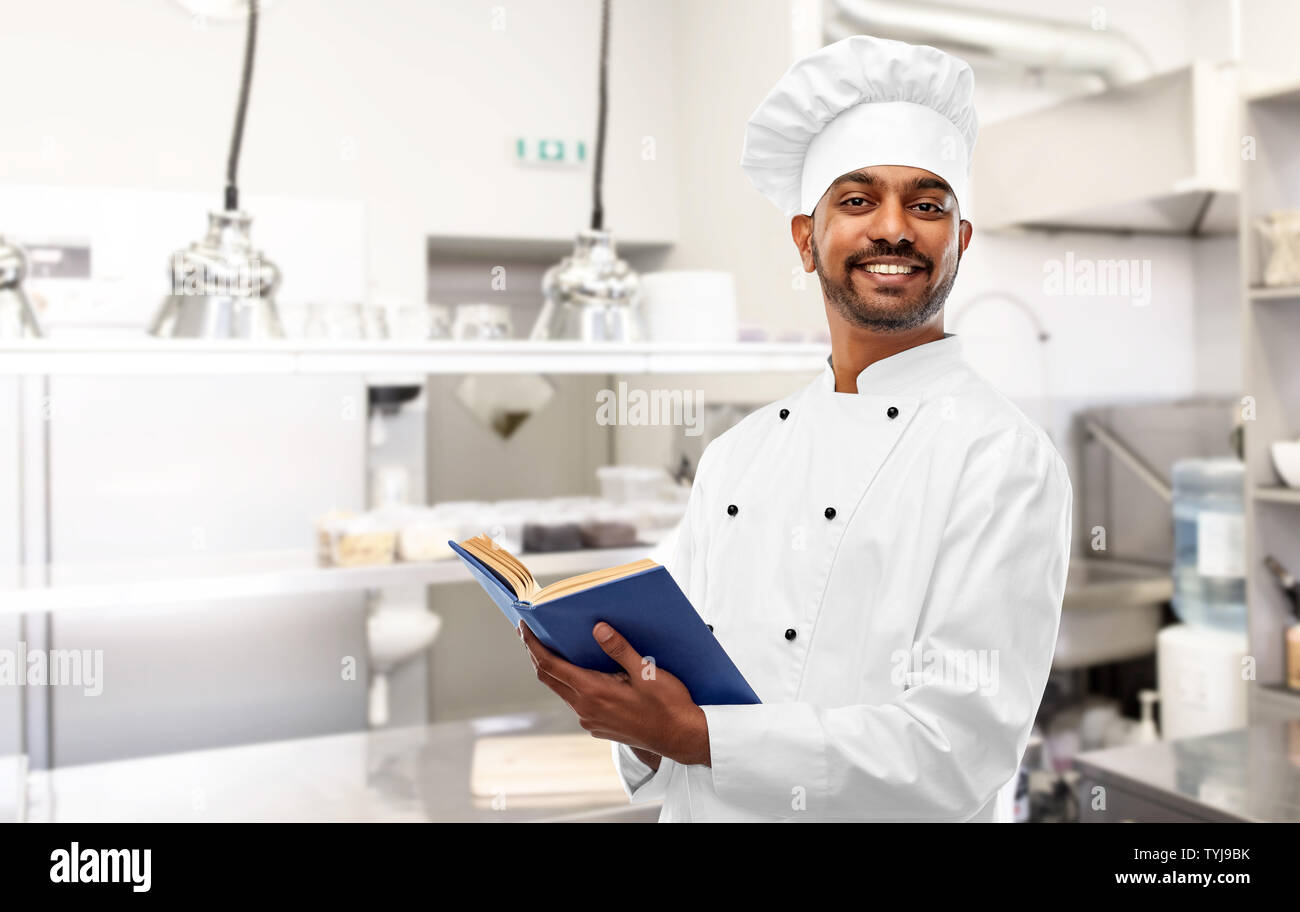happy indian chef with cookbook at kitchen Stock Photo - Alamy