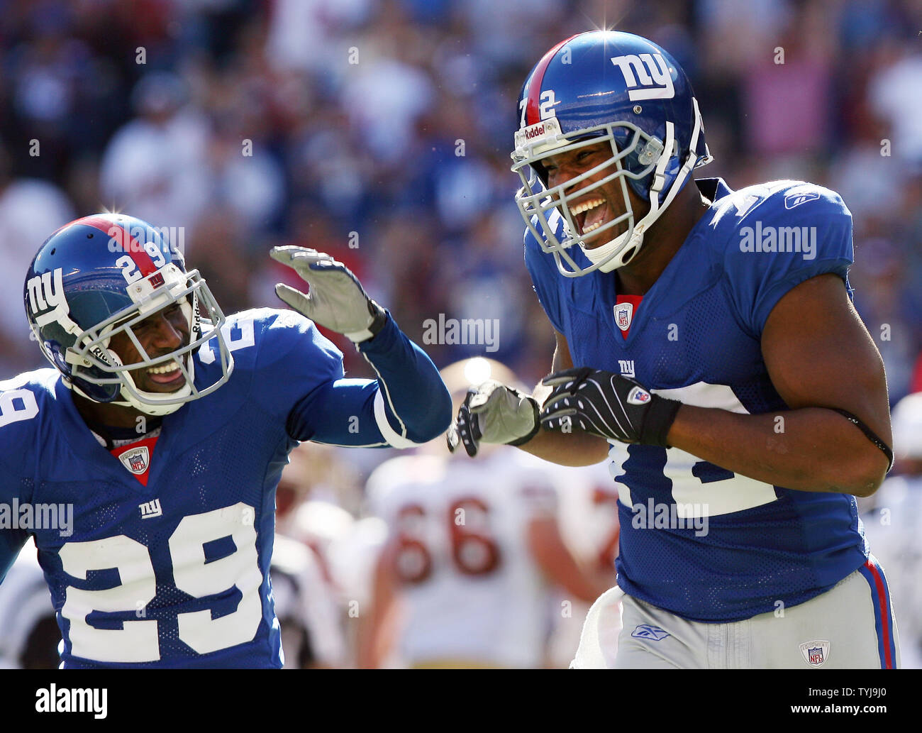 New York Giants Osi Umenyiora (72) laughs with Sam Madison while ...