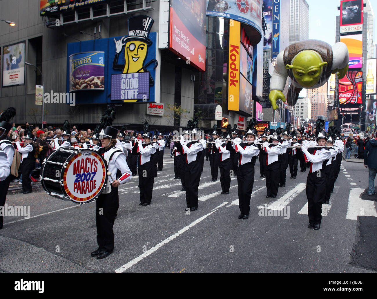 A marching band followed by a giant Shrek balloon marches down to ...